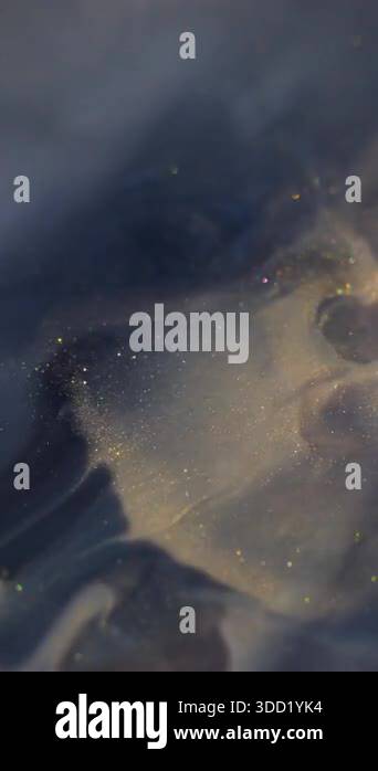 Vertical video. Shimmering liquid. Paint spill. Art sparkling particles ...
