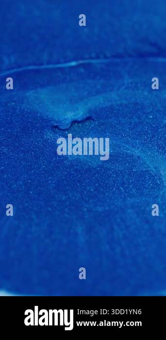 Vertical video. Ink blob. Pigment spill. Blue sparkling enamel art ...