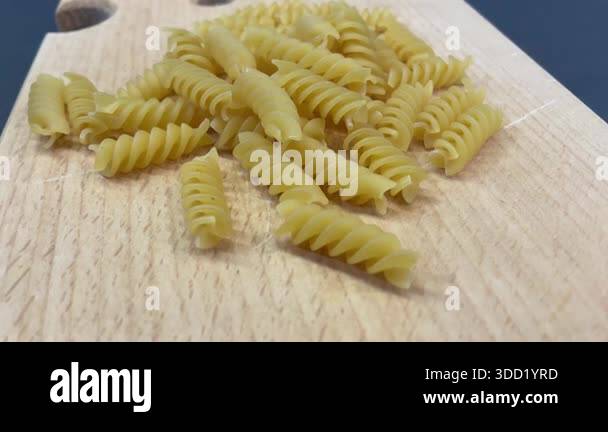 Pasta, cones, noodle cooking at the kitchen, wood, wooden table Stock ...