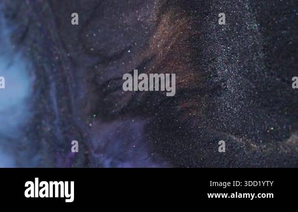 Shimmer ink. Sparkling flow. Defocused purple blue orange color glitter ...