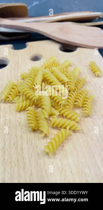 Pasta, cones, noodle cooking at the kitchen, wood, wooden table Stock ...