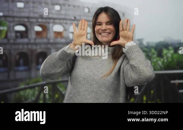 Young hispanic woman smiling joyfully in front of the iconic roman ...