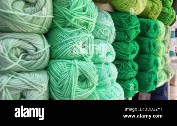 Many different types of green yarn are stacked on a shelf Stock Video ...