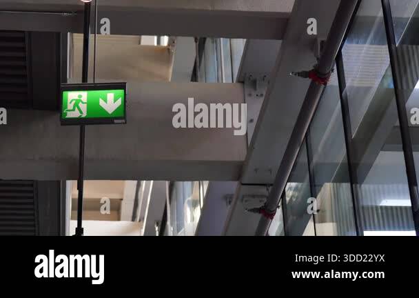 Signs show where to exit in the large, modern building Stock Video ...