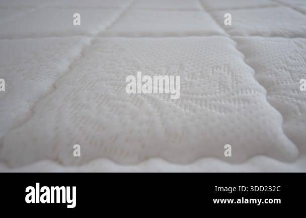 Exploring the texture and pattern of a white mattress fabric closely ...