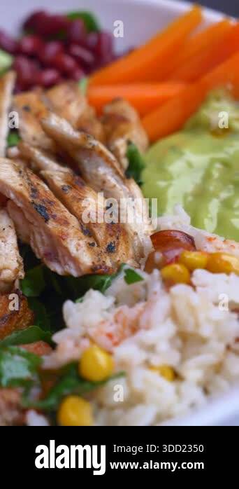 Sliced grilled chicken on a plate with rice and fresh vegetables Stock ...