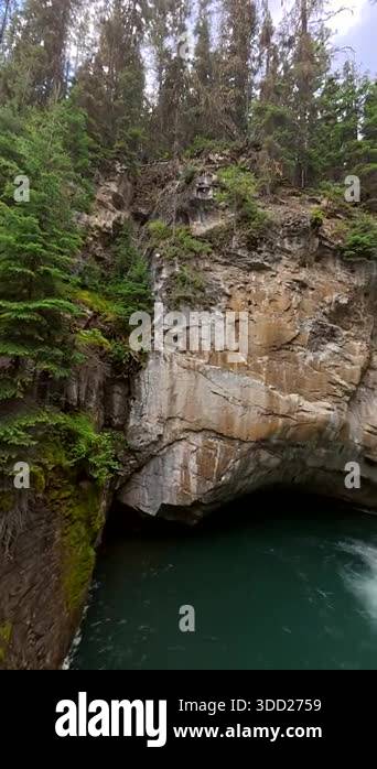 Turquoise water flows through johnston canyon in banff national park ...