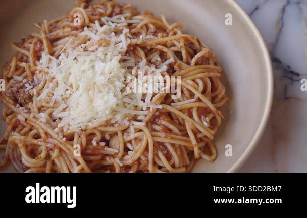 This shows the preparation of spaghetti with meat sauce and cheese ...