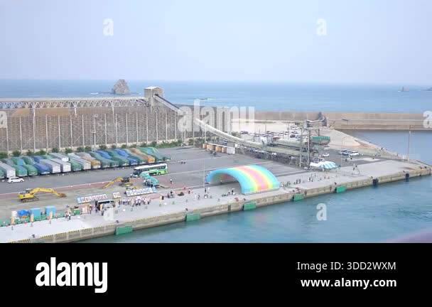 A large cargo port scene showing ships, cranes, containers, and ocean ...