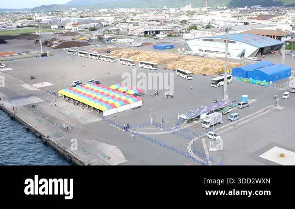 A large cargo port scene showing ships, cranes, containers, and ocean ...