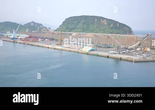 A large cargo port scene showing ships, cranes, containers, and ocean ...