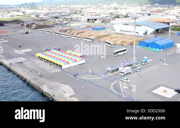 A large cargo port scene showing ships, cranes, containers, and ocean ...