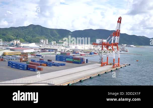 A large cargo port scene showing ships, cranes, containers, and ocean ...