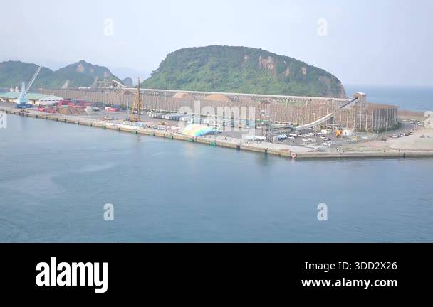 A large cargo port scene showing ships, cranes, containers, and ocean ...