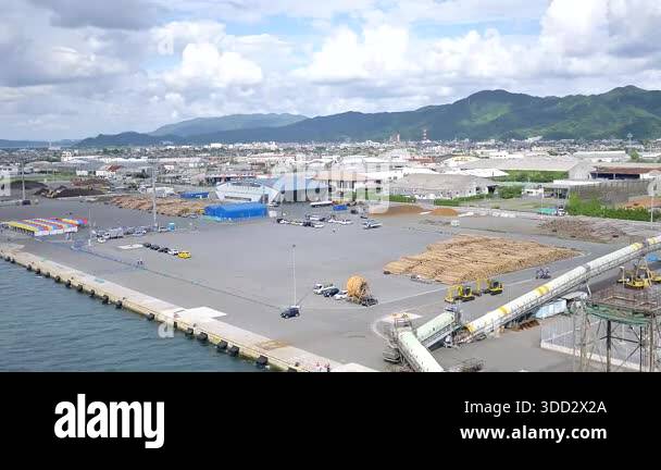 A large cargo port scene showing ships, cranes, containers, and ocean ...
