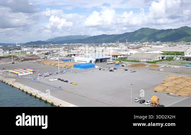 A large cargo port scene showing ships, cranes, containers, and ocean ...