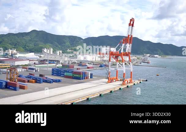 A large cargo port scene showing ships, cranes, containers, and ocean ...