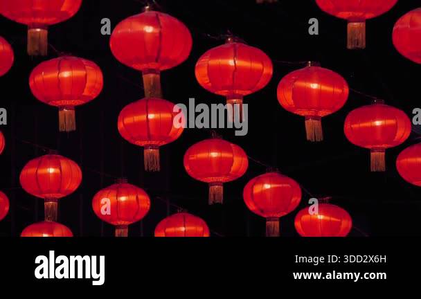 A stunning display of vibrant red Chinese lanterns hanging against a ...