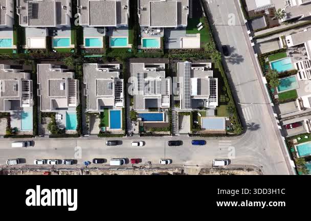 Top-down drone view of modern villas with pools and solar panels in La ...