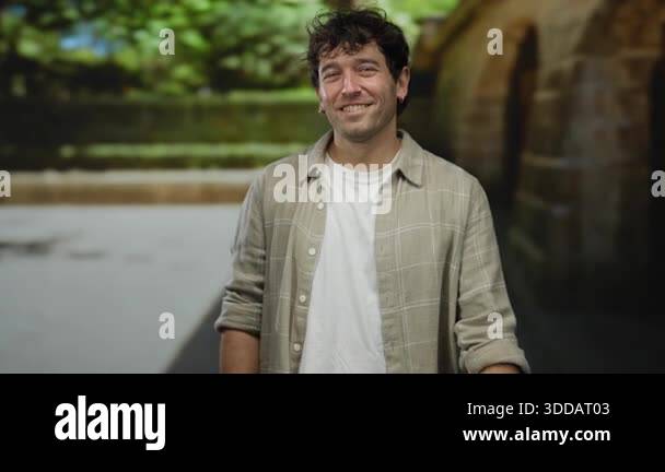 Smiling man standing in a picturesque mediterranean town with historic ...