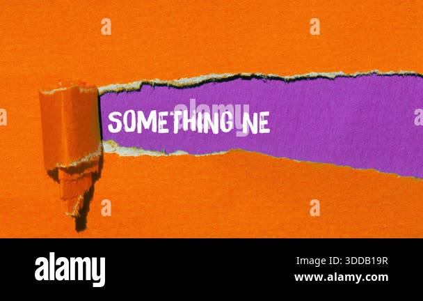 Something new is coming message writing on ripped torn paper background ...