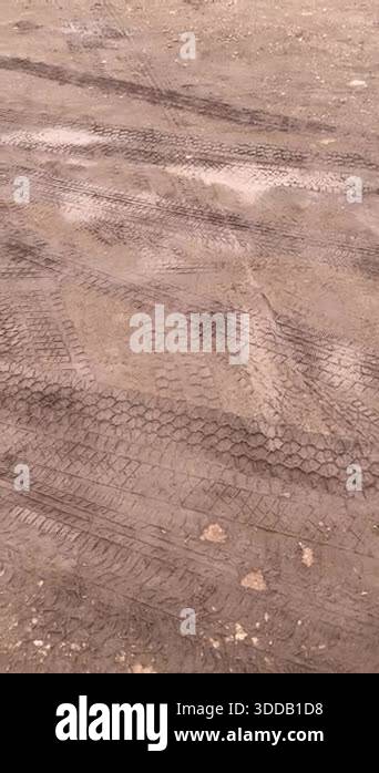 Curving tire marks on wet soil and gravel ground texture Stock Video ...