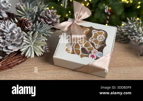 Christmas gift box with gingerbread cookies standing on a wooden table ...