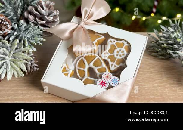 Festive gift box with gingerbread cookies on a table with christmas ...