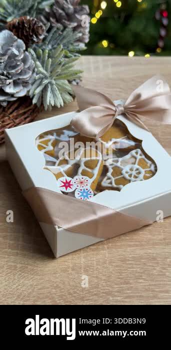 Gift box with homemade gingerbread cookies standing on a wooden table ...