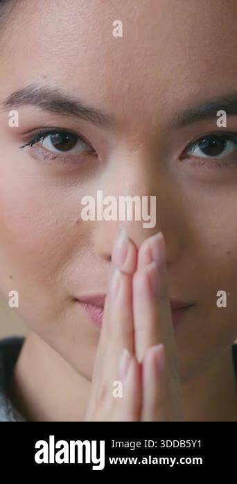Asian Japanese woman greeting folded hands looking camera bowing ...