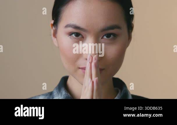 Asian Japanese woman greeting folded hands looking camera bowing ...