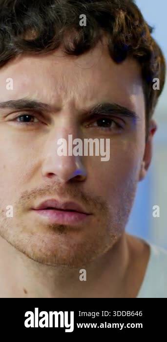 Disgusted confused young Caucasian man frowning looking at camera ...