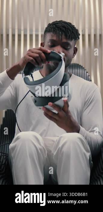 African American man putting on VR helmet in futuristic space modern ...