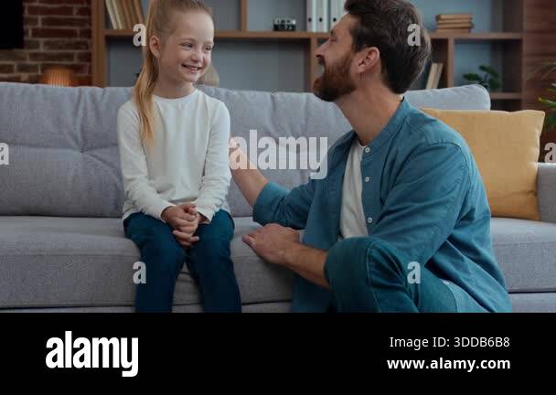 Happy Caucasian family at home dad talking with cute daughter give high ...