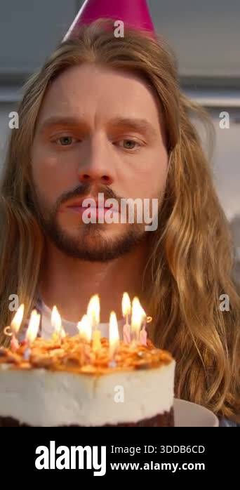 Upset frustrated Caucasian birthday man holding cake with candles at ...