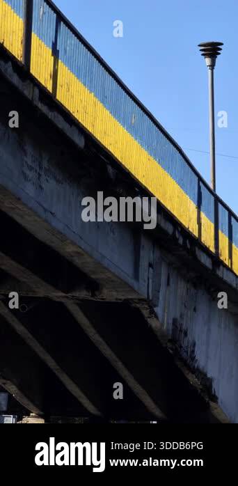 Low angle view of an old concrete bridge with its railing painted in ...