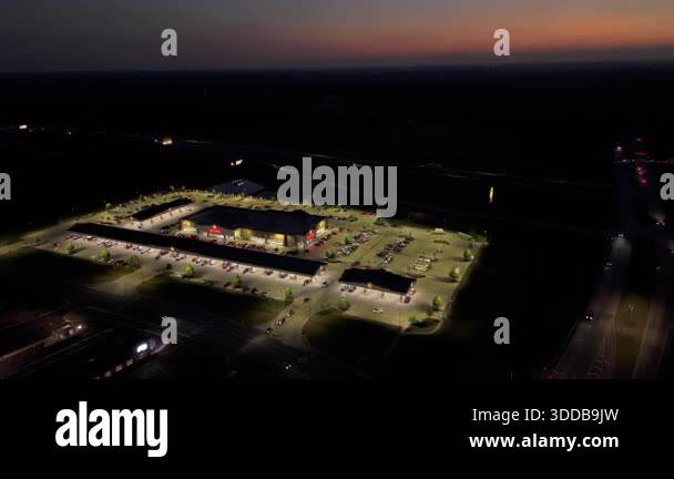 Drone evening wide footage of bright Bucees gas station near highway in ...