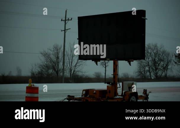 Illuminated warning display sign ROAD CLOSED during a nighttime ...
