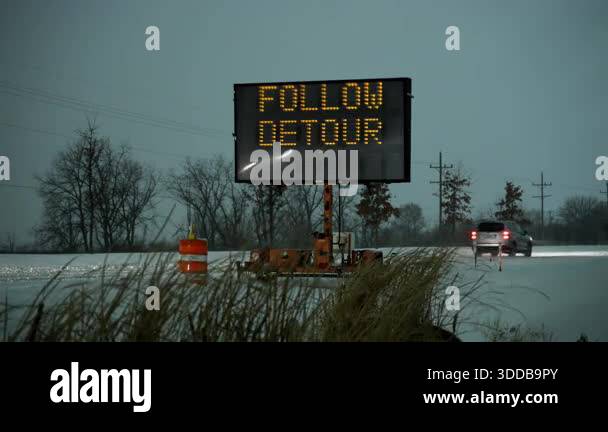 Illuminated warning display sign ROAD CLOSED during a nighttime ...