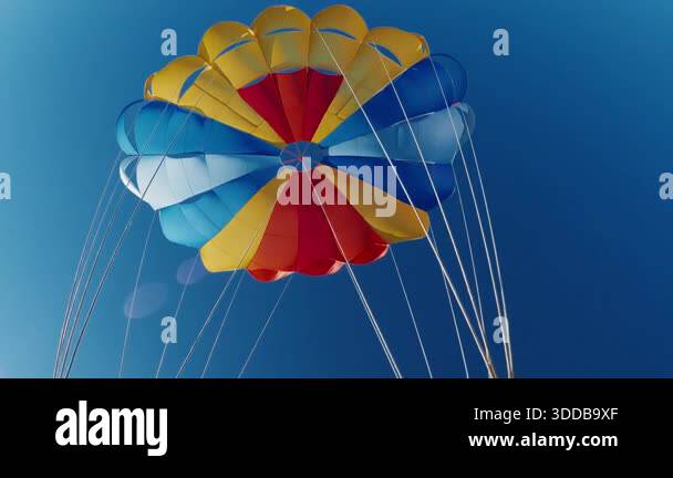 Colorful Parasail Canopy Against Clear Sky, Vibrant Red Yellow Blue ...