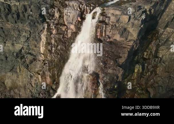 Aerial Waterfall Cascading Down Rugged Cliff Over Mossy Faroe Islands ...