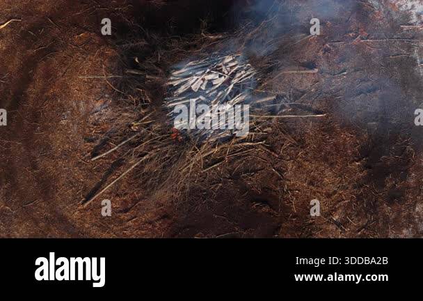Aerial drone footage showing smoke rising from a land-clearing burn ...