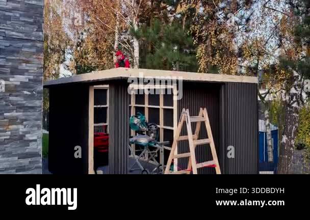 Workers are constructing a new structure in a backyard during autumn ...