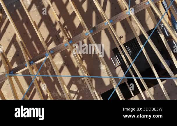 Workers are building a wooden structure on a construction site. Cut ...