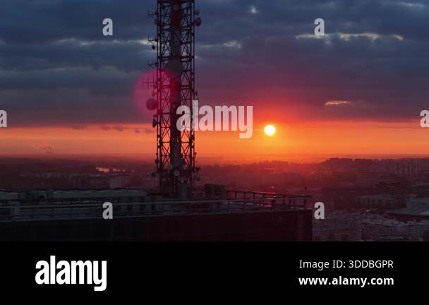 Aerial drone view of a large telecommunications tower set against an ...