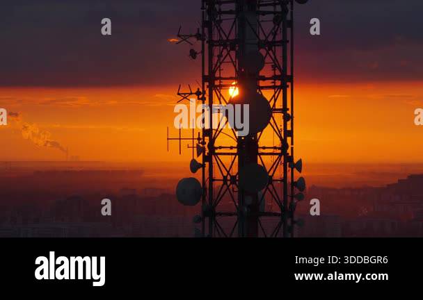 Aerial drone view of a large telecommunications tower set against an ...