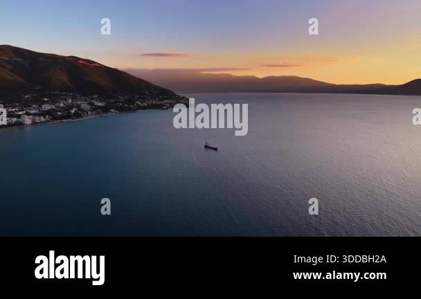 Aerial drone view of a lone fisherman rowing his small wooden boat ...