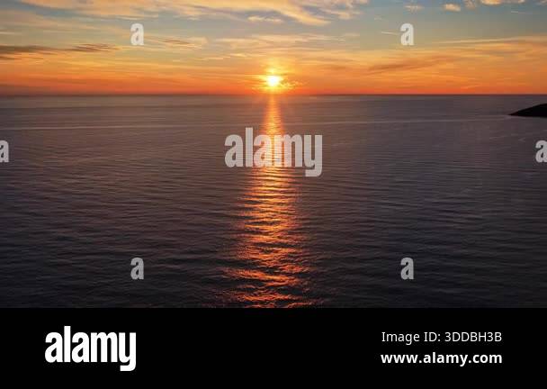 Aerial drone view of a sunset across the open Adriatic Sea, with the ...