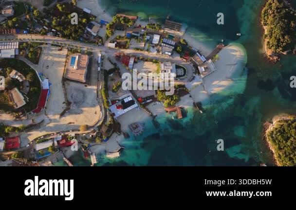 Aerial drone view of Ksamil town, it's dense cluster of hotels and ...