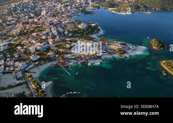 Aerial drone view of Ksamil town, it's dense cluster of hotels and ...